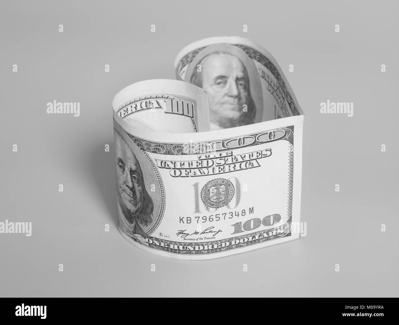 100 dollar bill in heart shape Black and White Stock Photos & Images ...