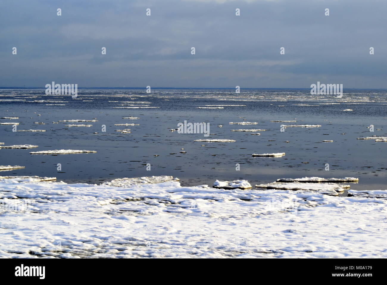 The dramatic cloudy sky over the Baltic sea. Winter coastal landscape ...