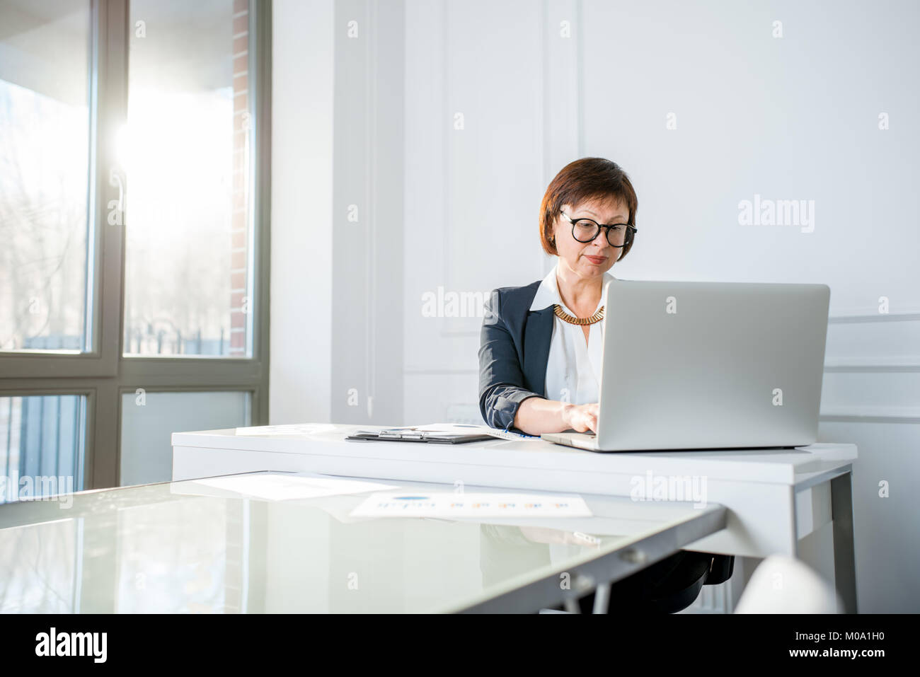 Female senior manager sitting in office hi-res stock photography and ...