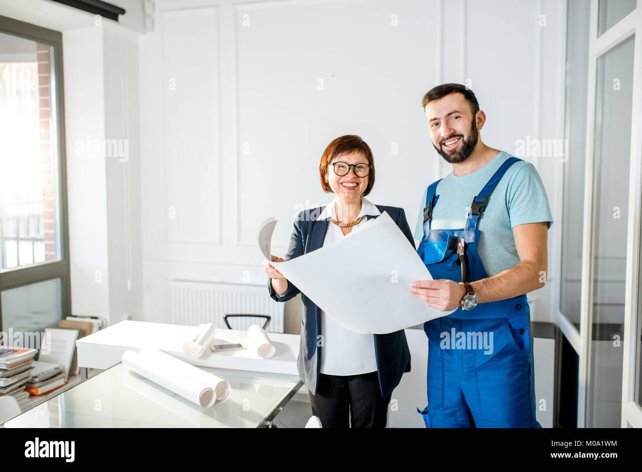 Repairman with senior architect or client at the office Stock Photo - Alamy