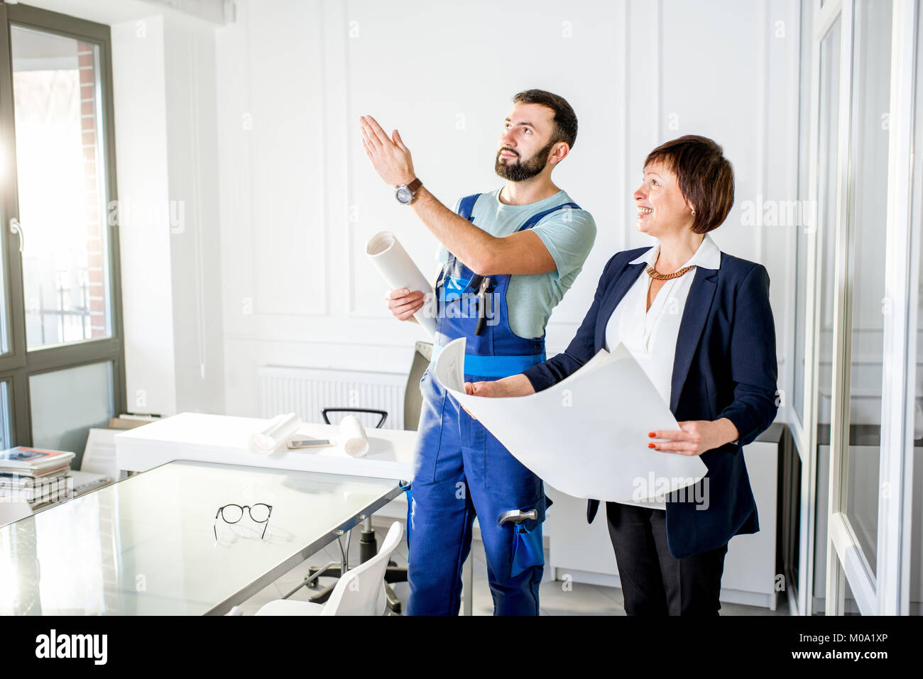 Repairman with senior architect or client at the office Stock Photo - Alamy