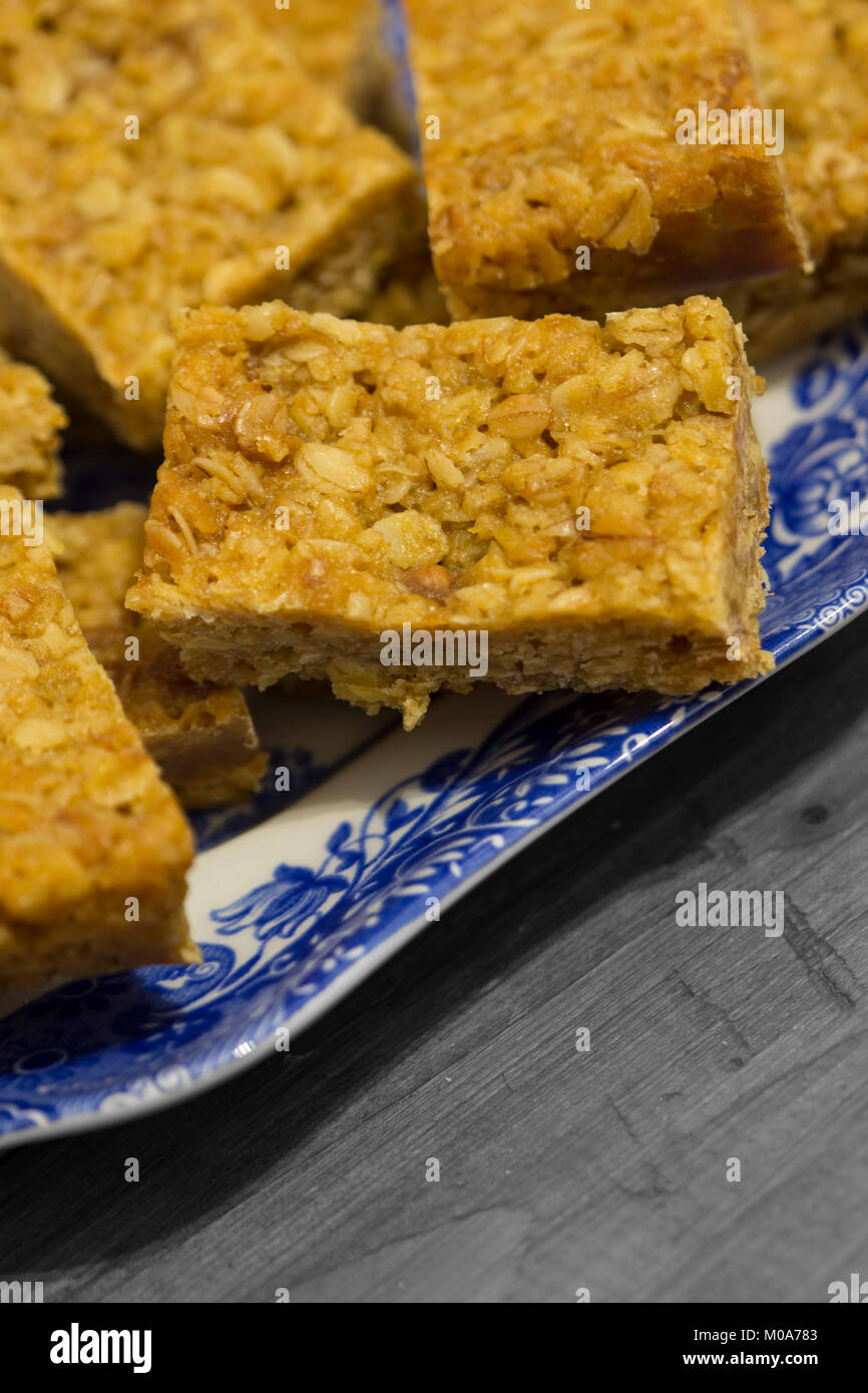 Caramel flapjacks on a dish with wood background Stock Photo - Alamy