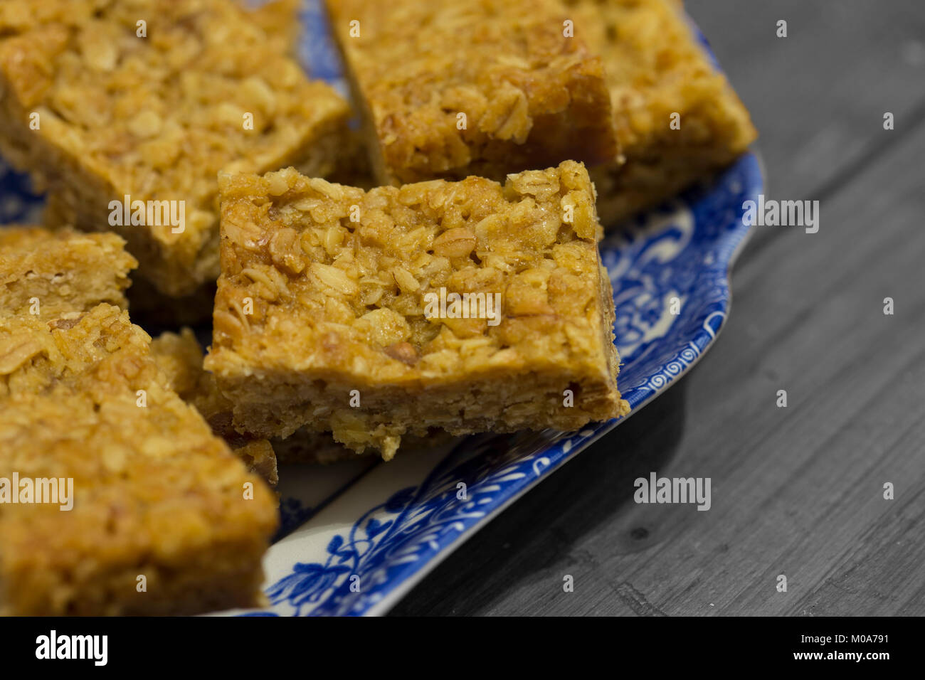 Caramel flapjacks on a dish with wood background Stock Photo - Alamy