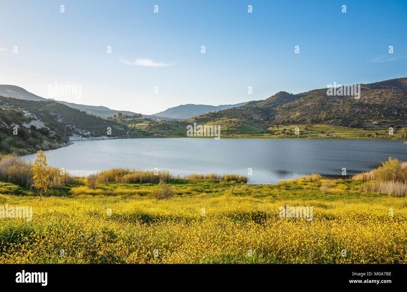 Cyprus landscape with mountains, lake and village Stock Photo - Alamy