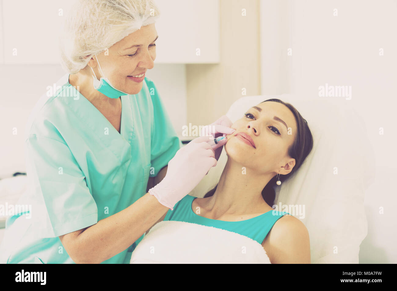 Female client receiving cosmetic injection from professional ...
