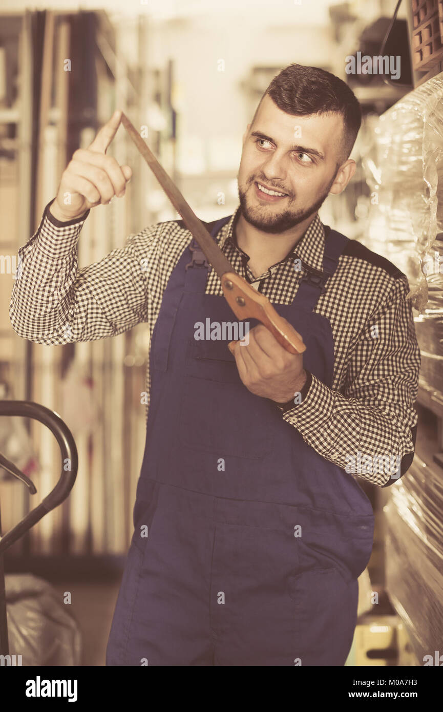 Cheerful male worker showing his working tools at workshop Stock Photo ...