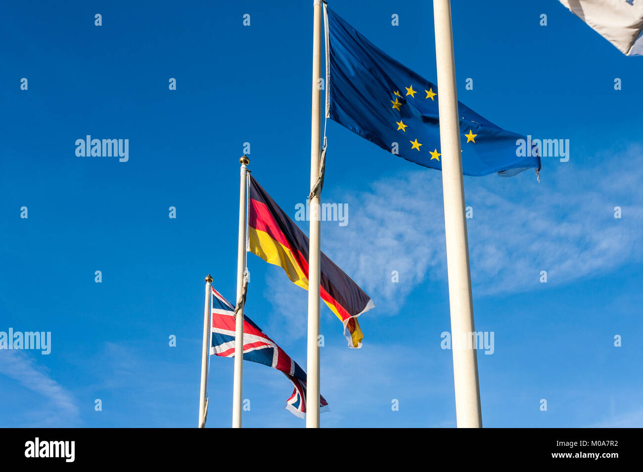 EU Flag, German Flag and UK Flag fly side by side in the breeze Stock ...
