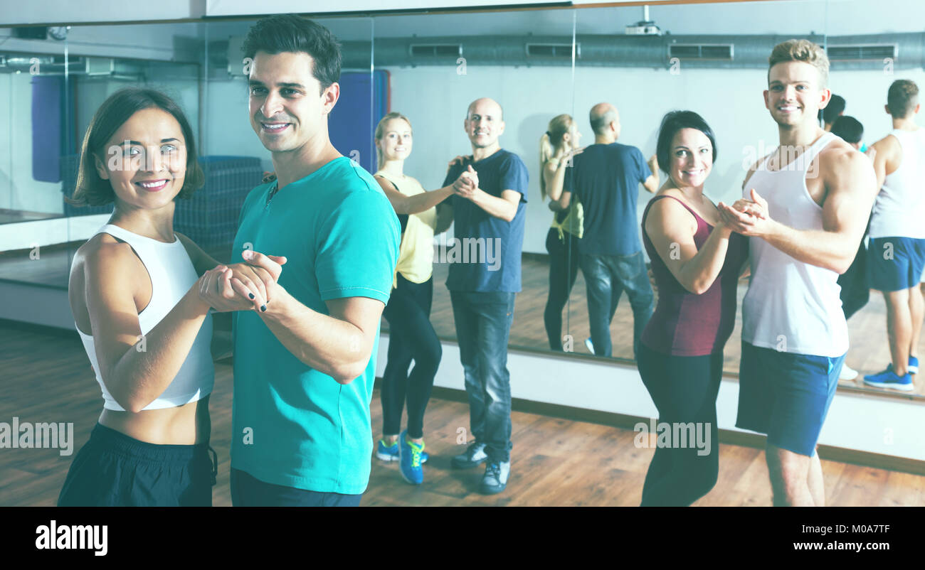 Smiling dancing couples learning salsa at dance class Stock Photo - Alamy