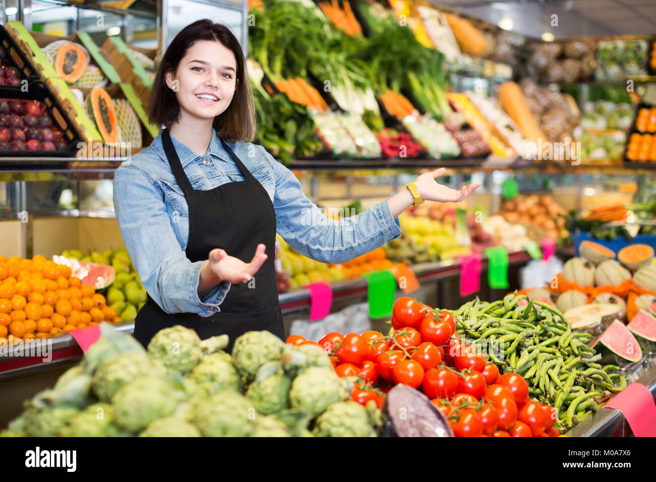 happy american female shopping assistant demonstrating assortment of ...