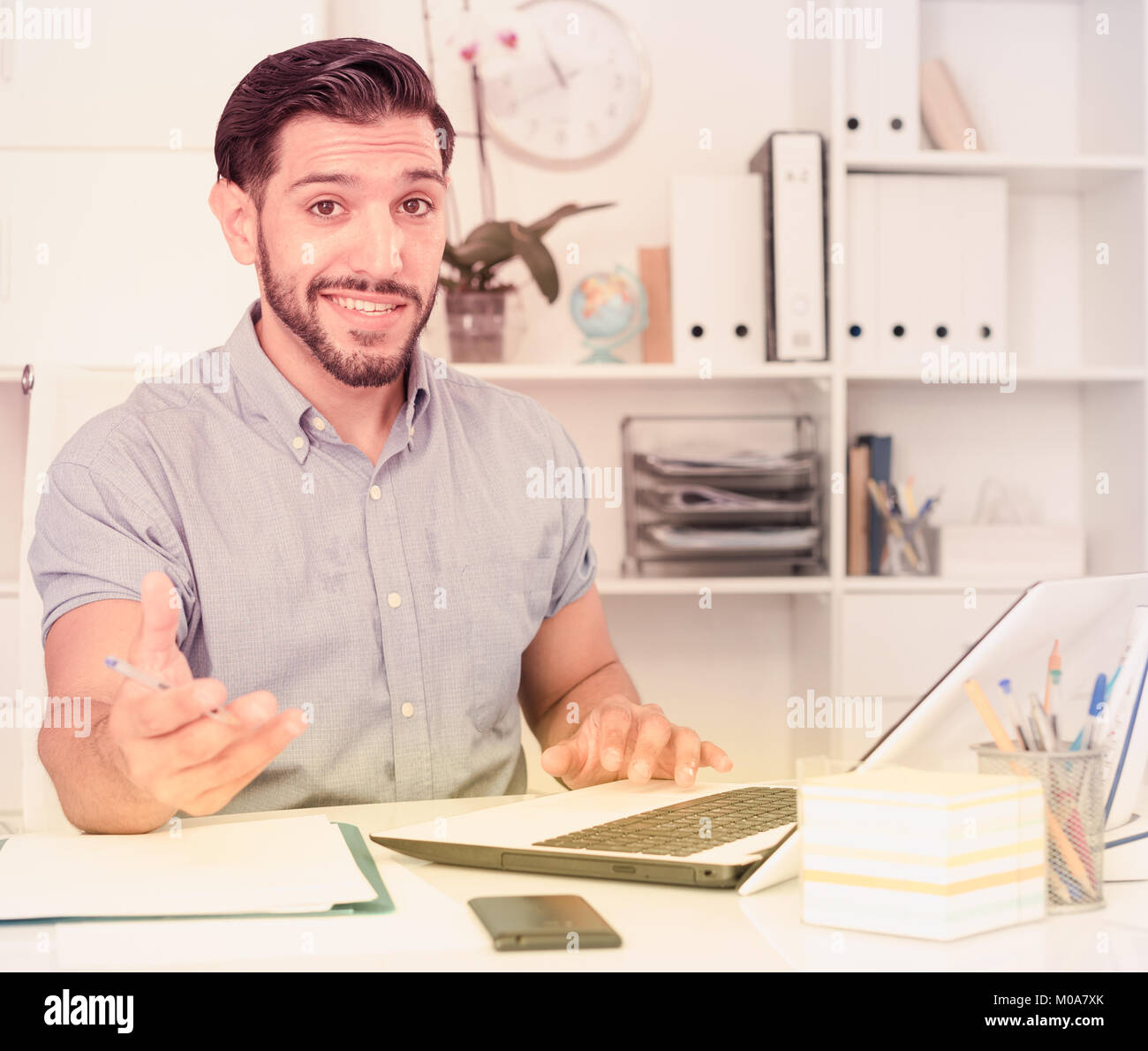 Spanish businessman is talking with partner about contract in office ...