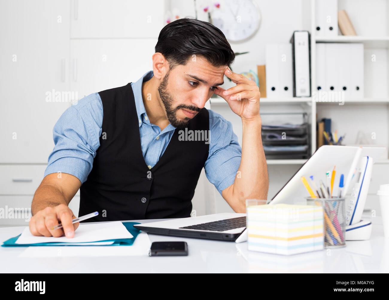 Spanish male worker is having complicated issue with project in office ...