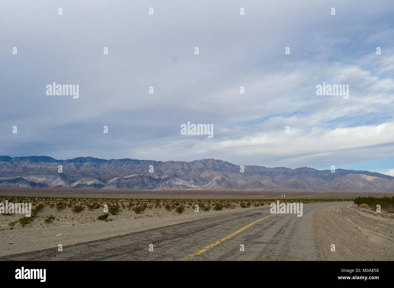 Empty road going through Death Valley National Park, CA, USA Stock ...