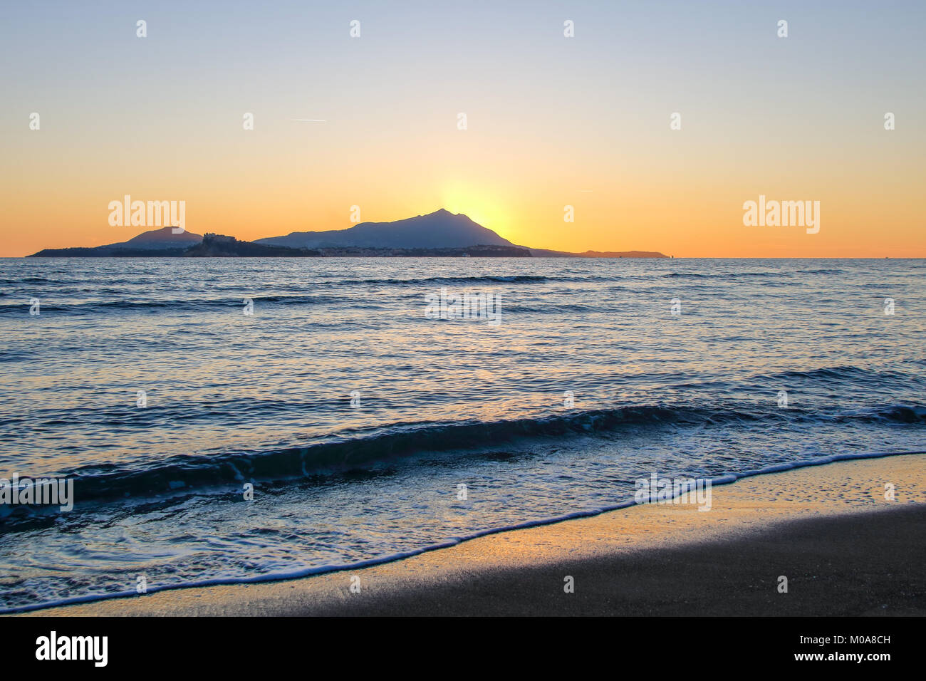 the beach of Miseno at sunset with Procida island on the background ...