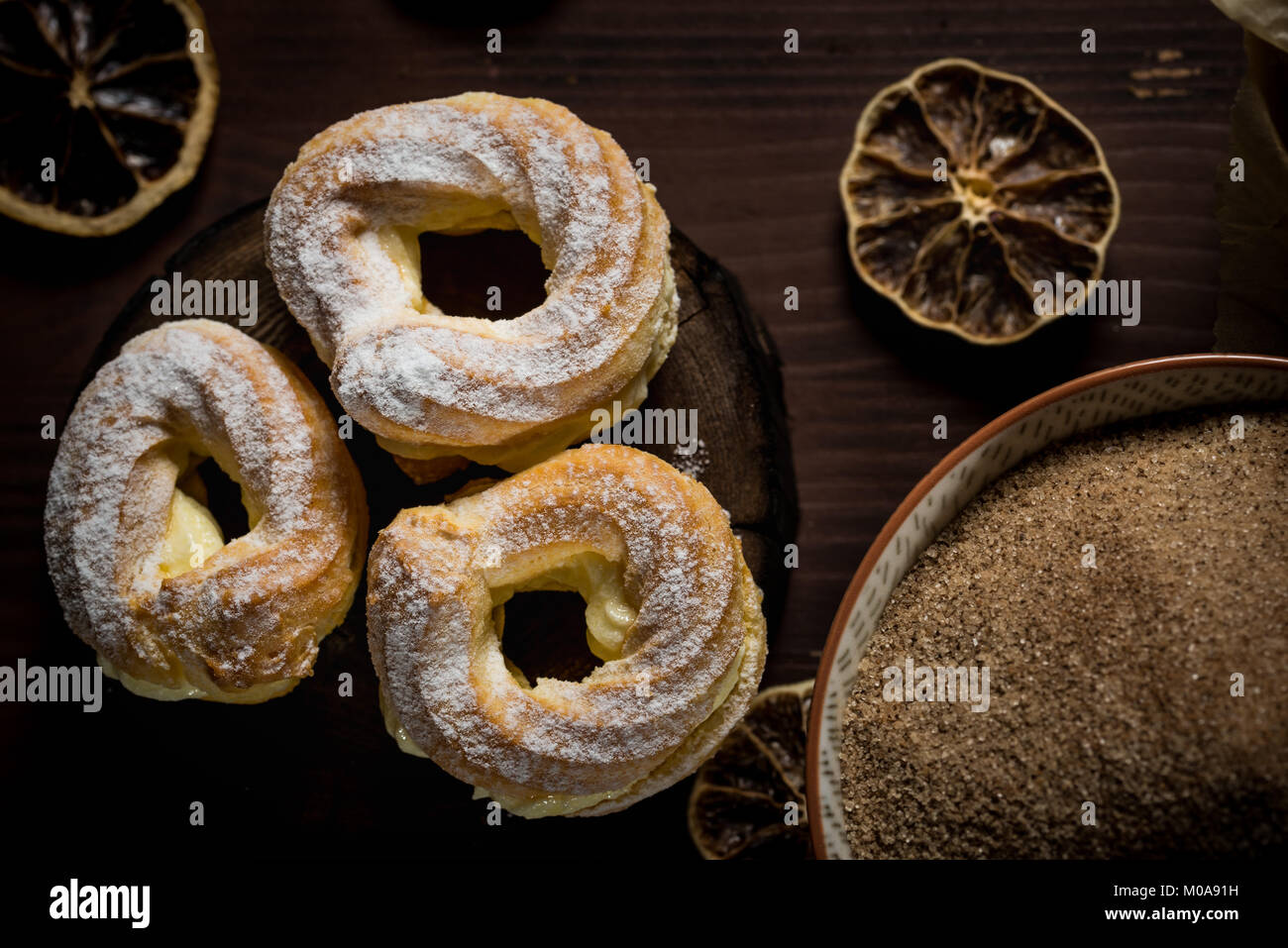 Horizontal photo of three cream puffs filled by cream and covered by ...