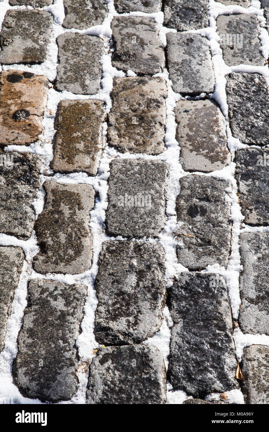 Vintage cobblestone street with fallen snow Stock Photo - Alamy