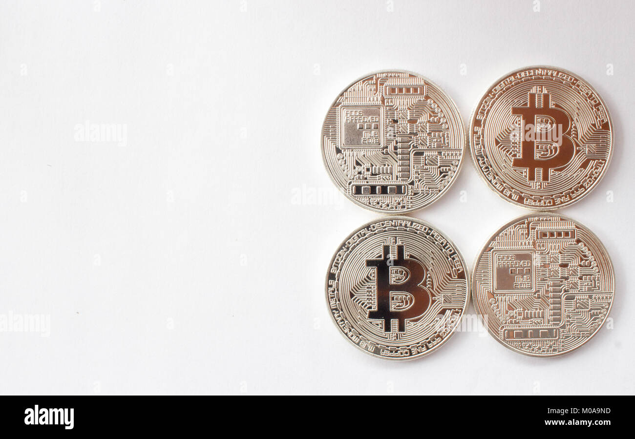 On a white background are silver coins of a digital crypto currency ...