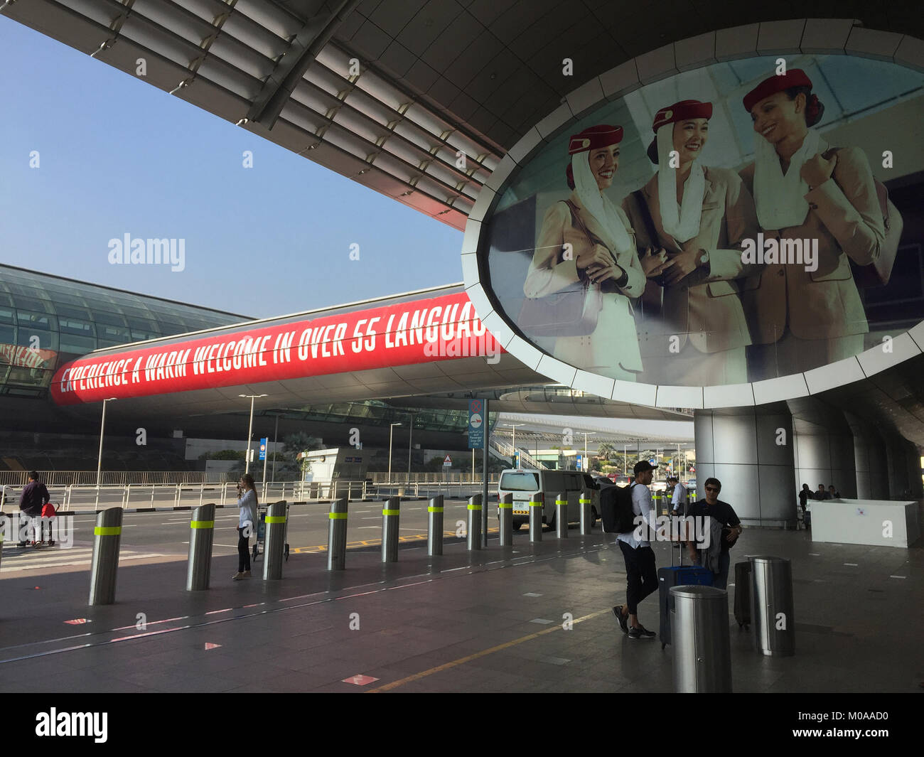 DUBAI INTERNATIONAL AIRPORT with sign showing Emirates air stewardesses ...
