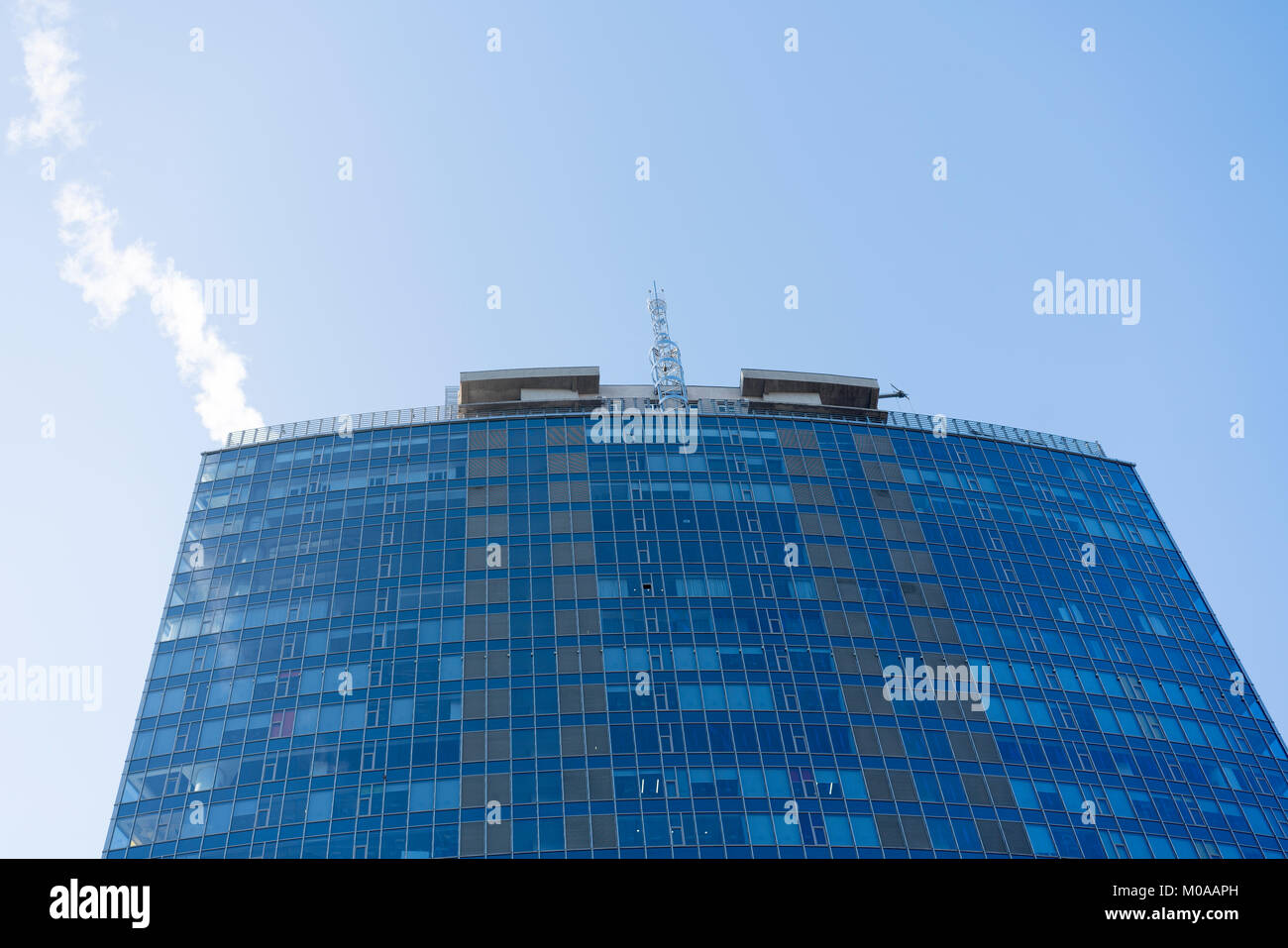 Glass triangular tall building against the blue sky Stock Photo - Alamy