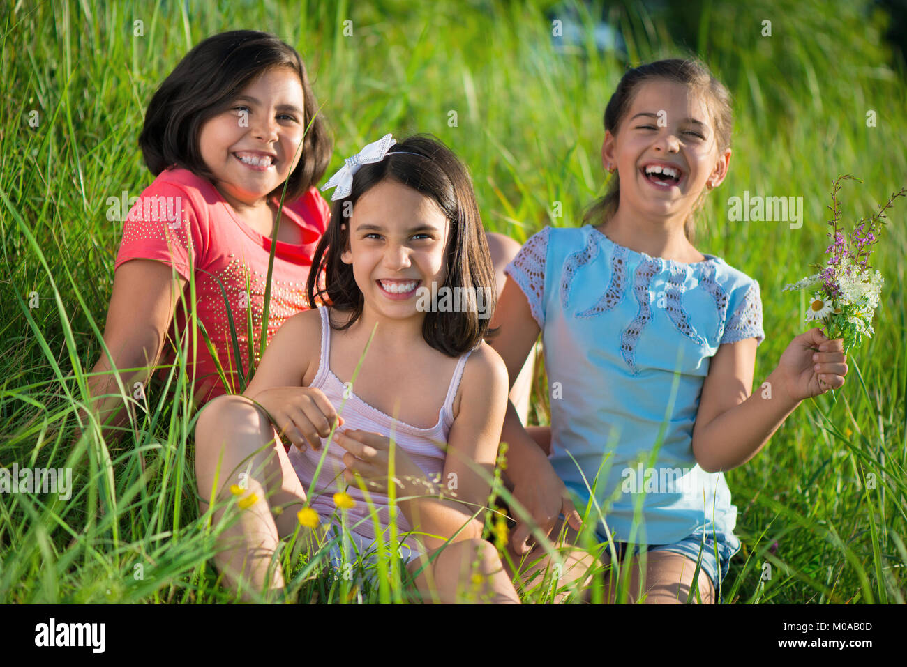 Three happy teen girls having fun at park Stock Photo - Alamy