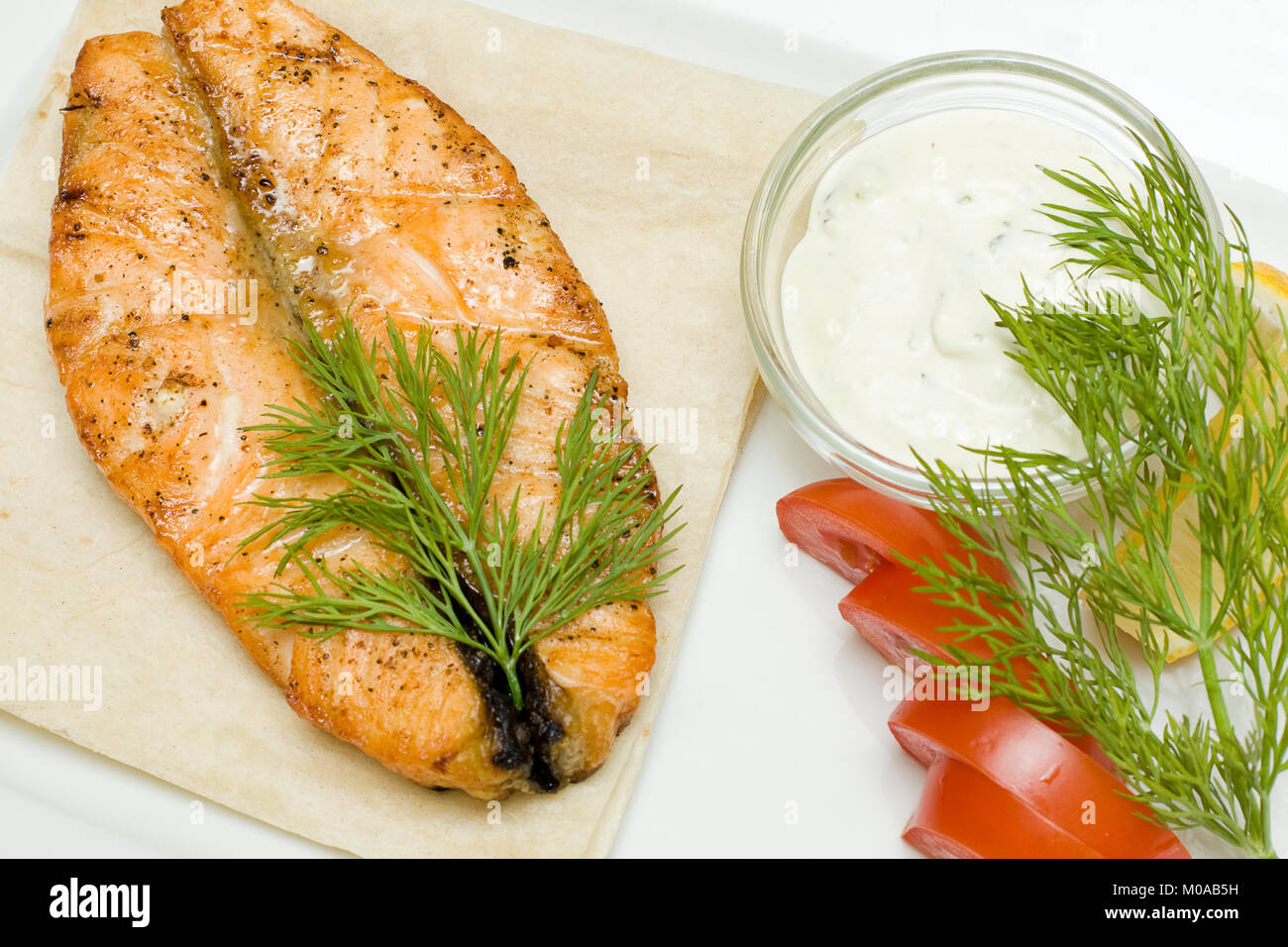 tatsy food with fish, vegetables and souce Stock Photo - Alamy