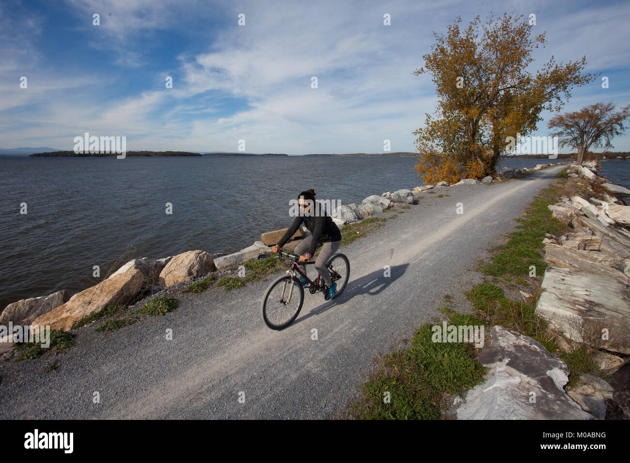 Female bike rider on a beautiful path with Fall colors Stock Photo - Alamy