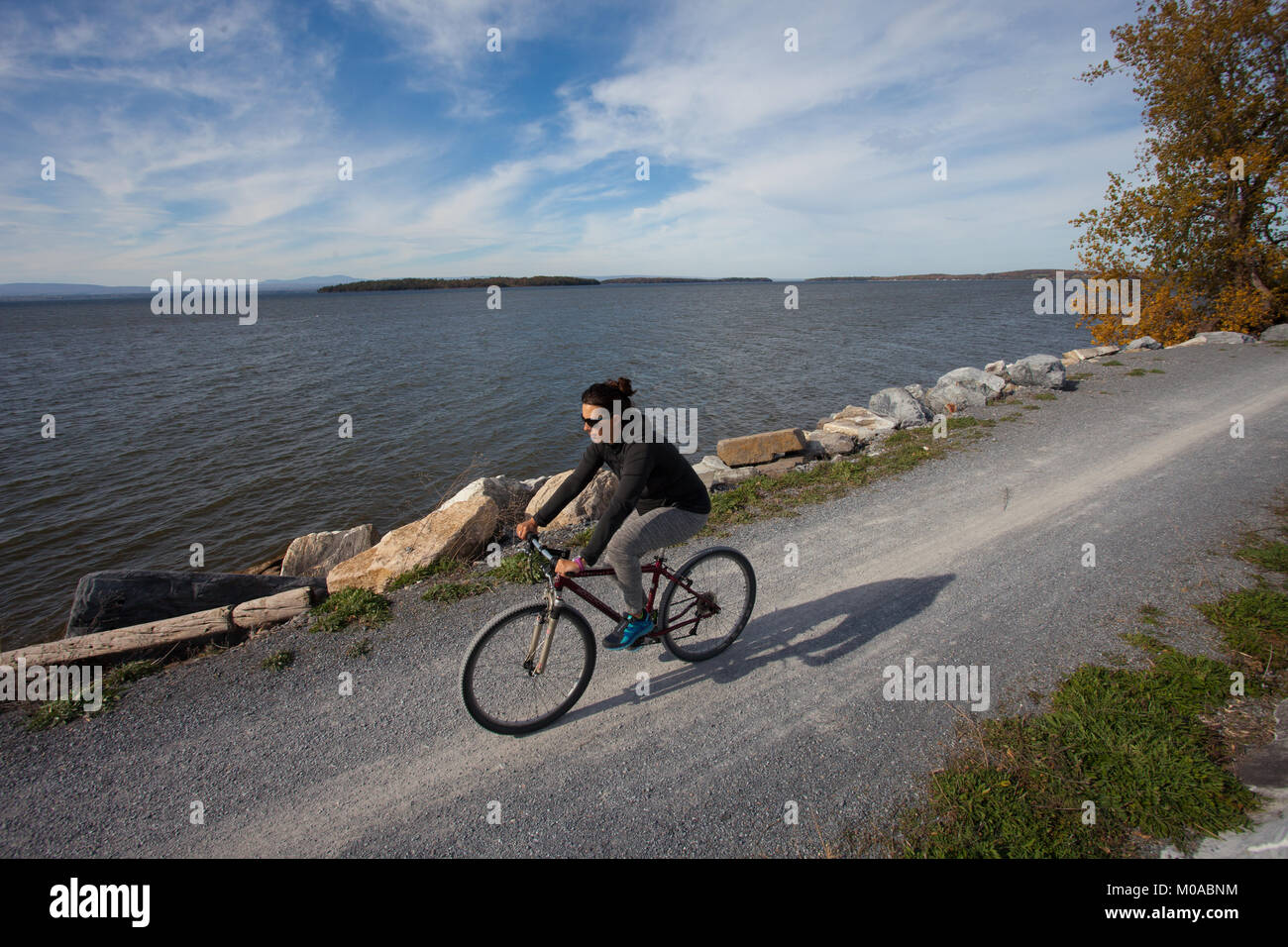 Female bike rider on a beautiful path with Fall colors Stock Photo - Alamy