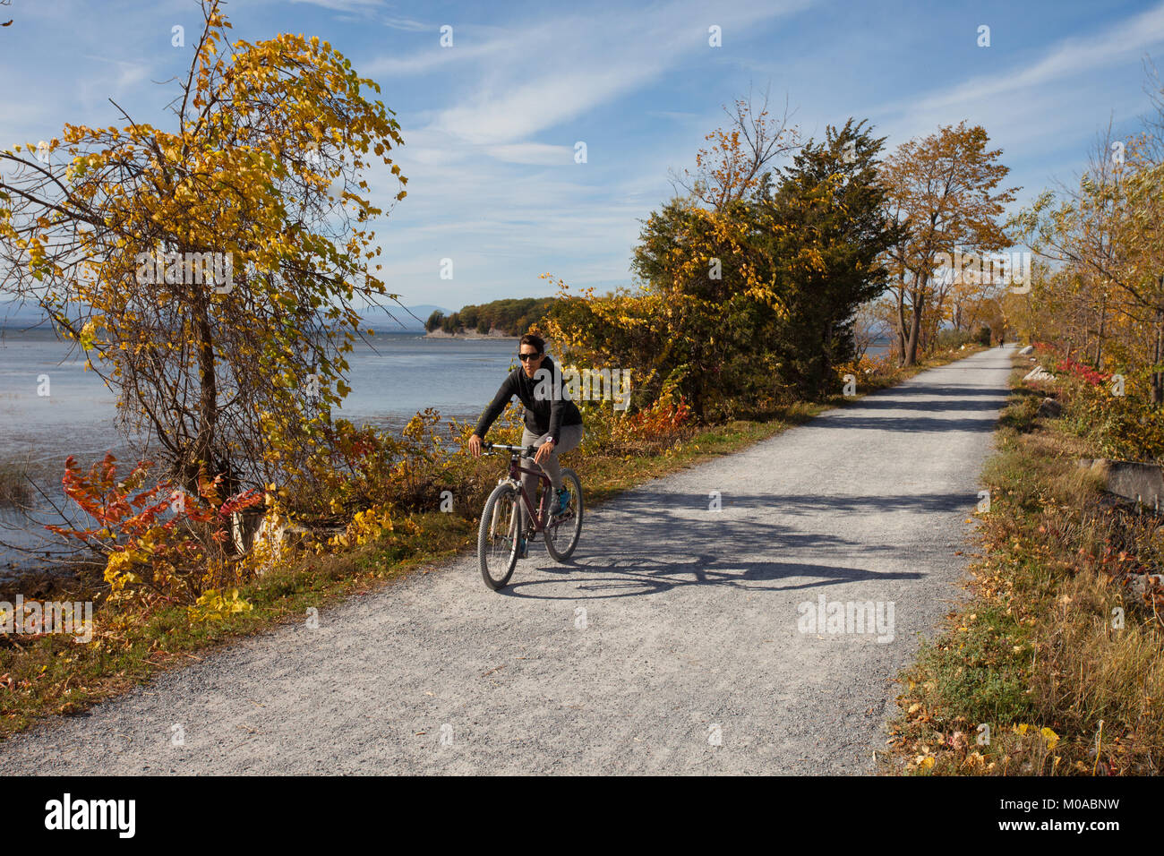 Female bike rider on a beautiful path with Fall colors Stock Photo - Alamy