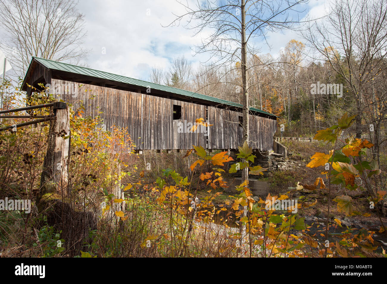Wooden covered bridge in Vermont with Fall colors Stock Photo - Alamy