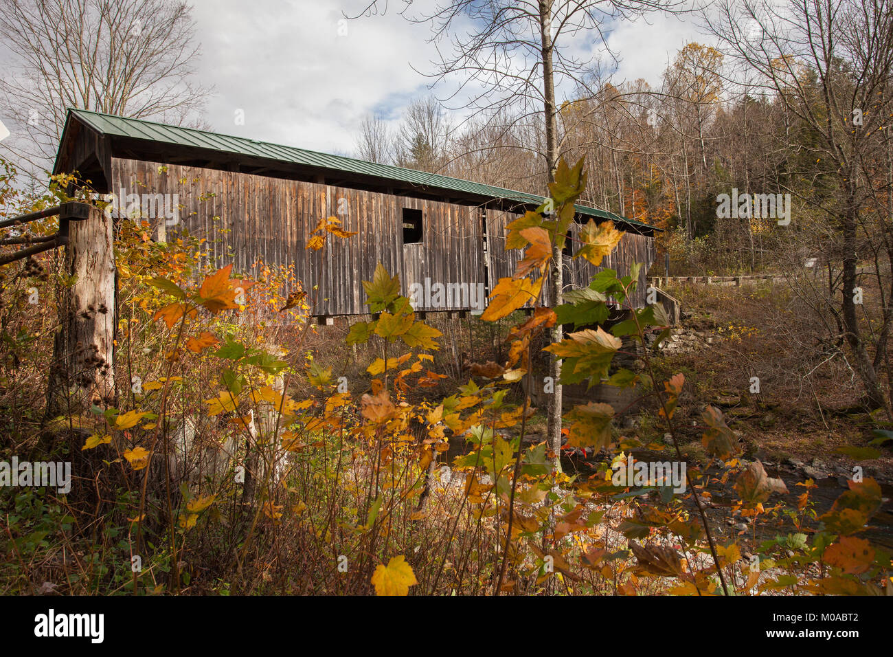 Wooden covered bridge in Vermont with Fall colors Stock Photo - Alamy