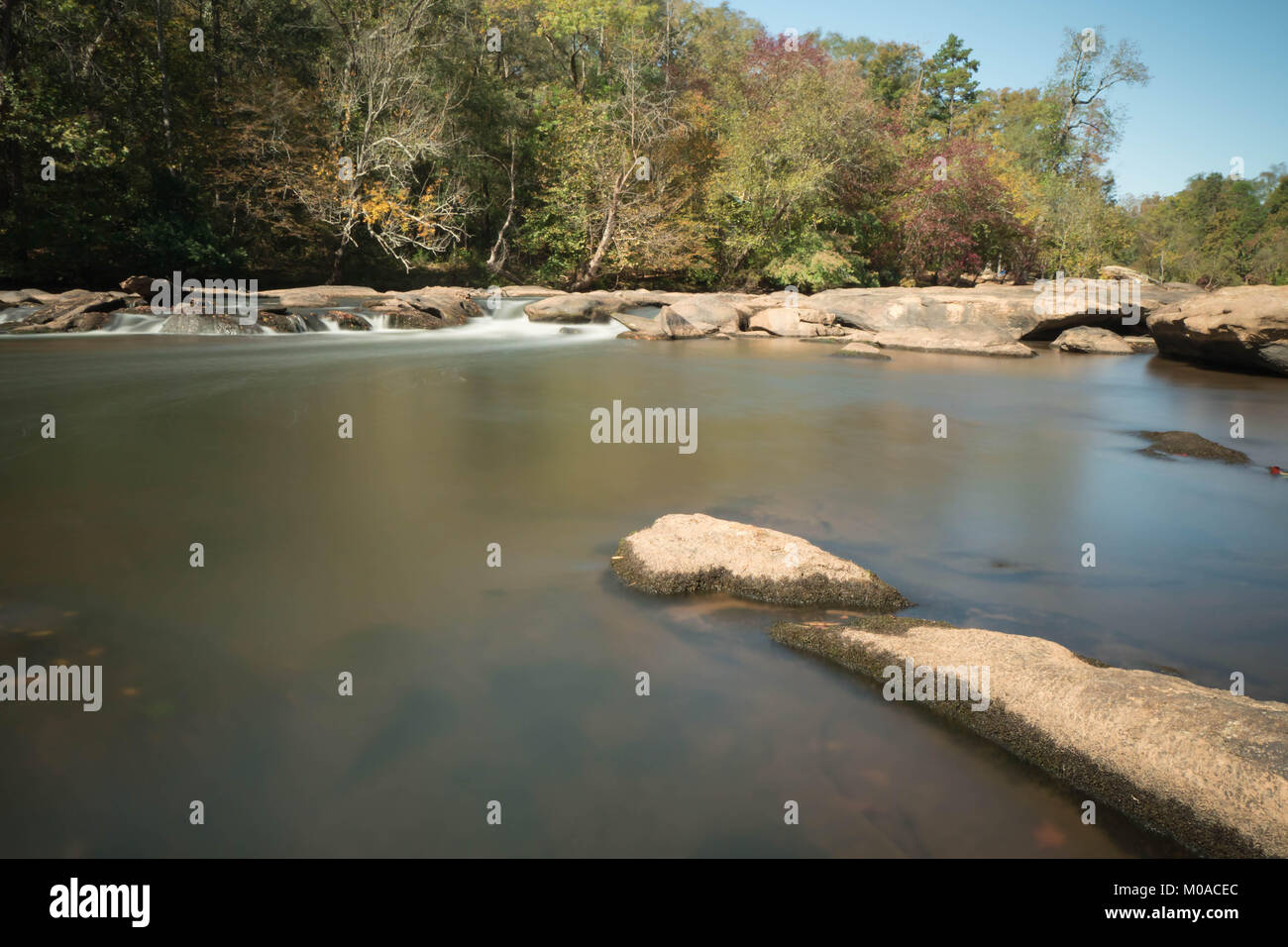 beautiful small creek landscape in late autumn with rocks and flowing ...