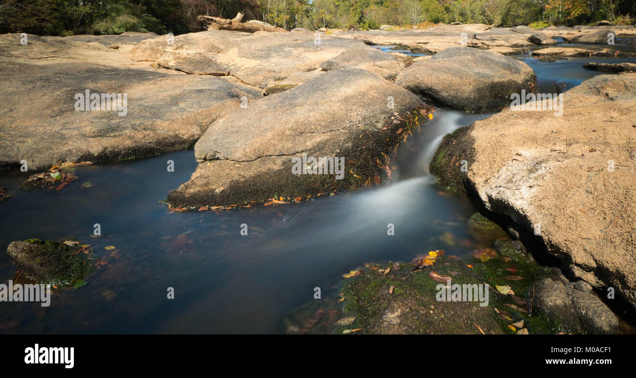 beautiful small creek landscape in late autumn with rocks and flowing ...