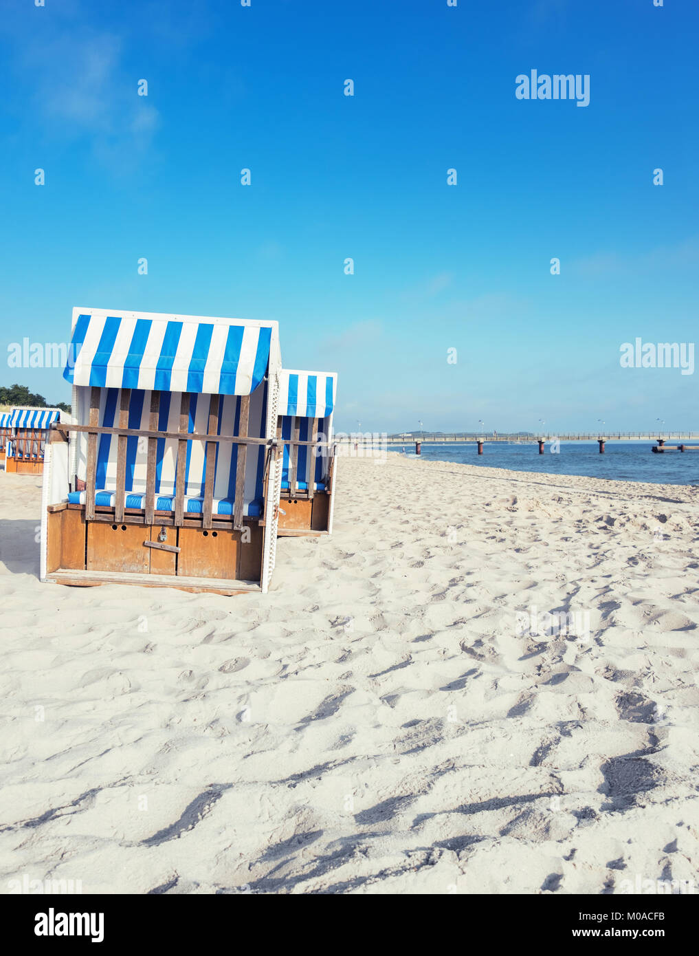Sandy beach and traditional wooden beach chairs on island Rugen ...
