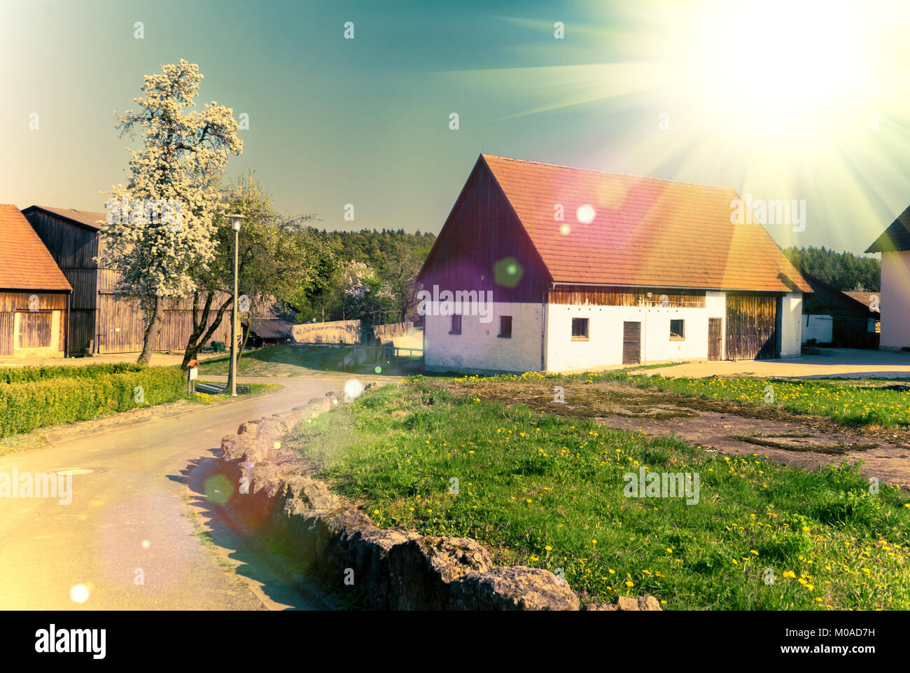 Sun shines over rural house in Germany, tinted image Stock Photo - Alamy