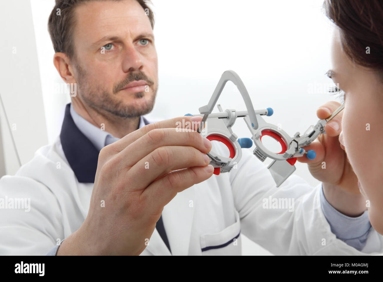 optician hands with trial frame, optometrist doctor examines eyesight ...