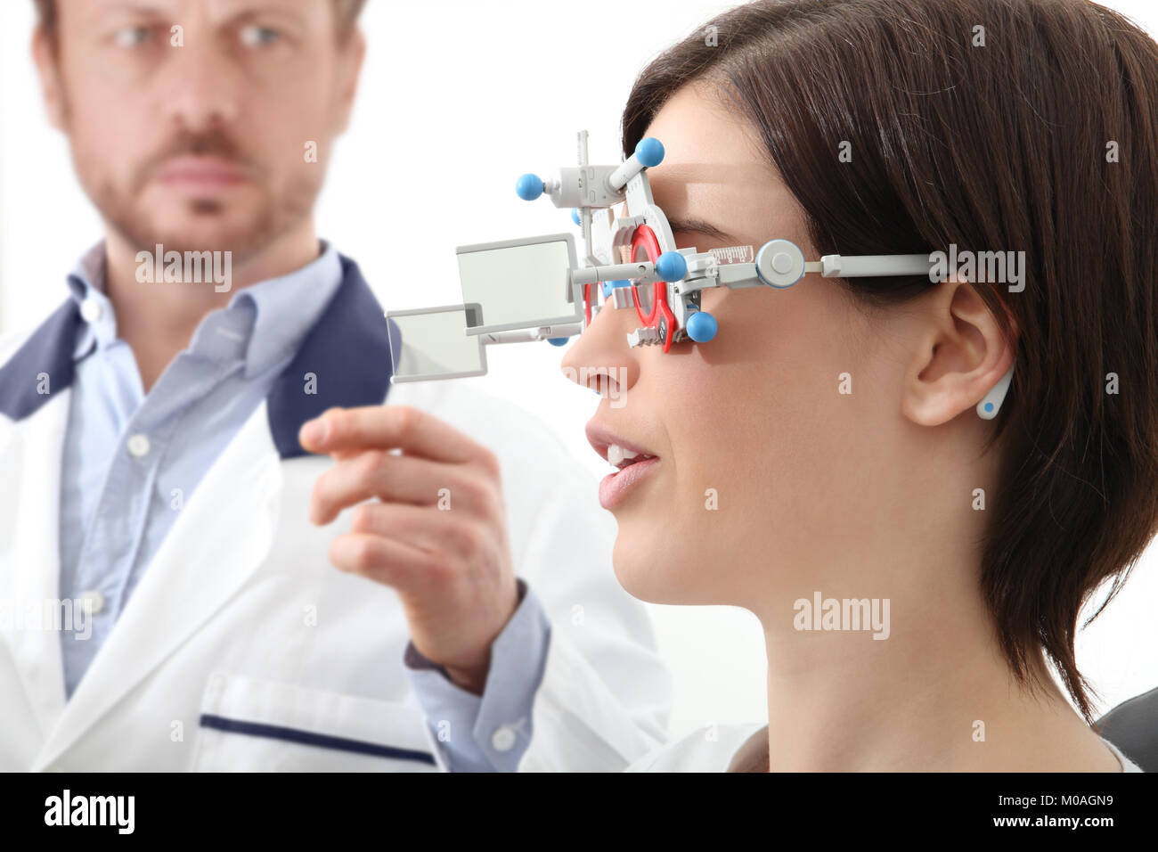 optometrist with trial frame examining eyesight woman patient in optician office Stock Photo - Alamy