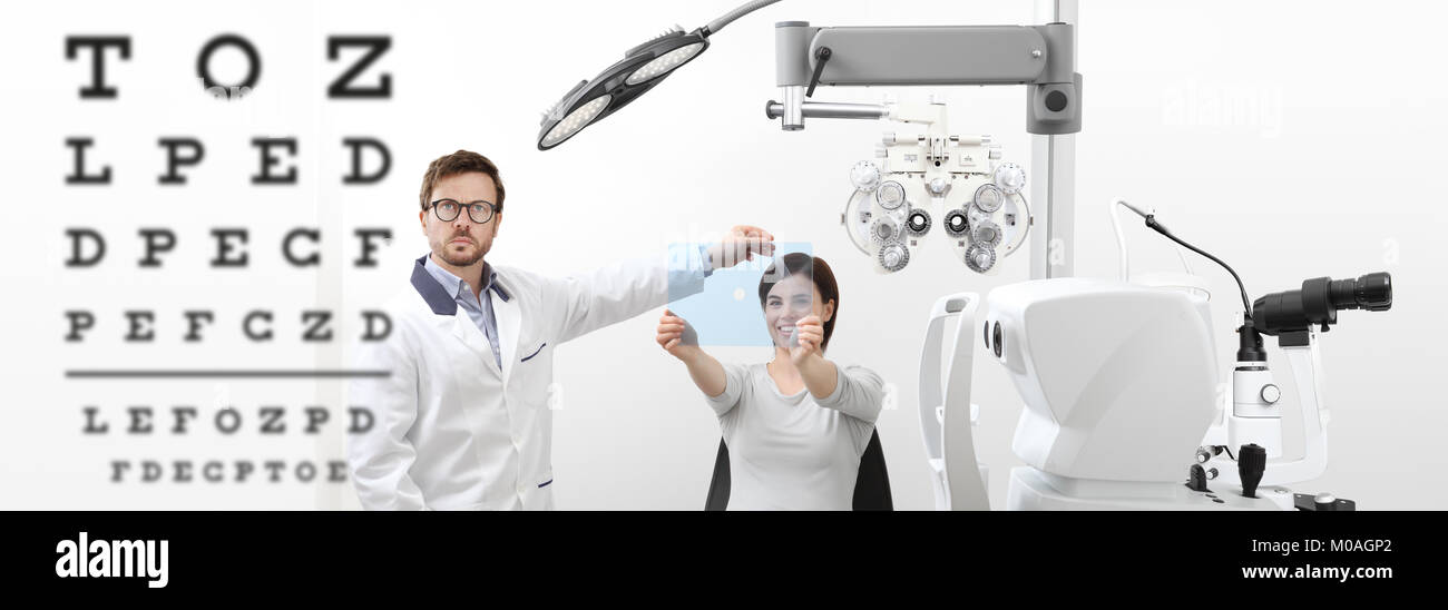 optometrist examining eyesight woman patient pointing chart at the hole ...