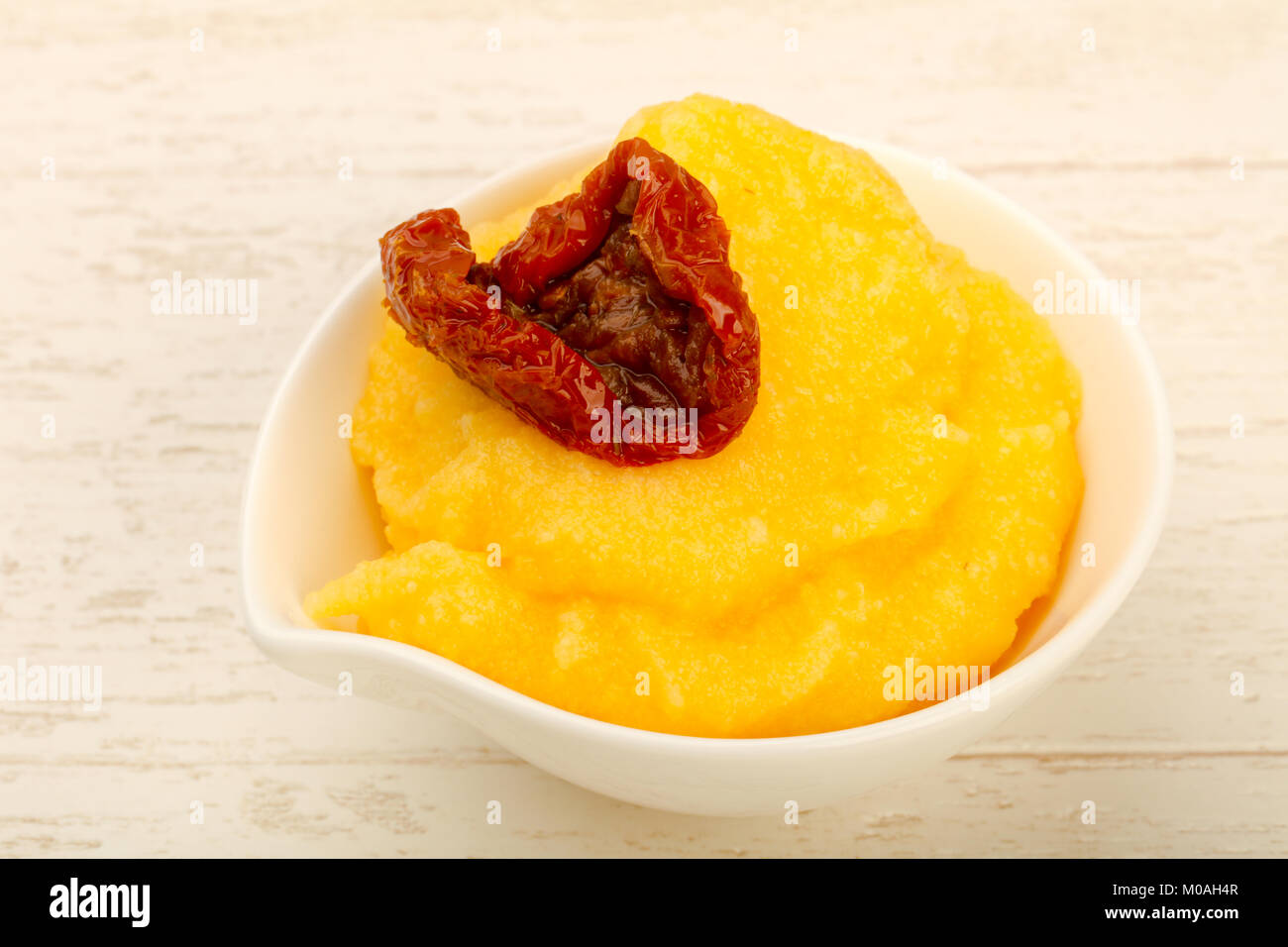 Polenta with dry tomato Stock Photo - Alamy
