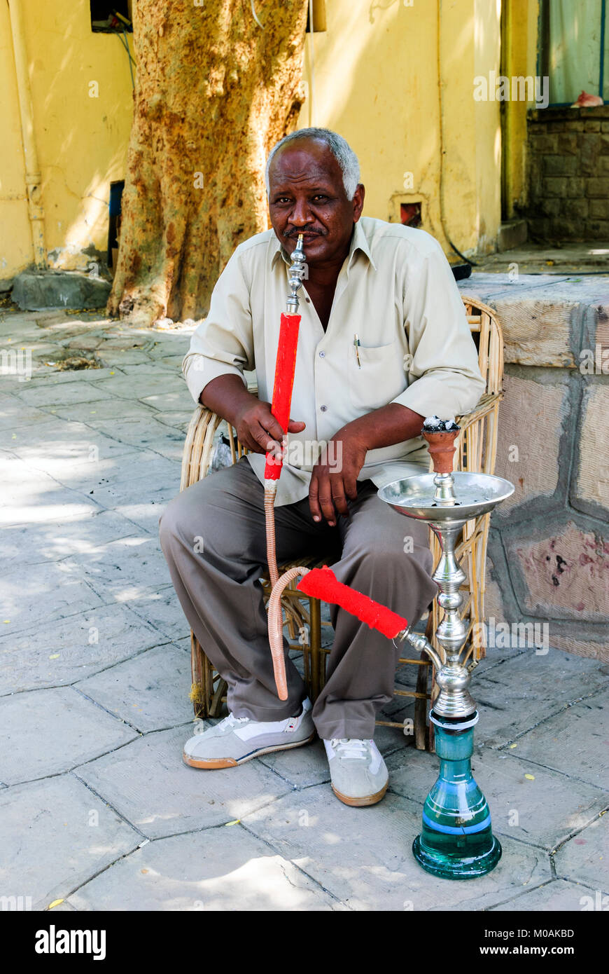 Nubian man smoking shisha pipe in Kitchener's island gardens - Aswan ...