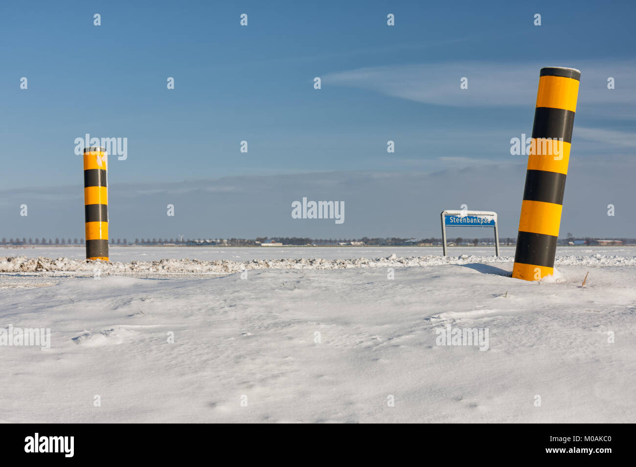 Dutch winter landscape with snowy farmland and colorful road signs ...