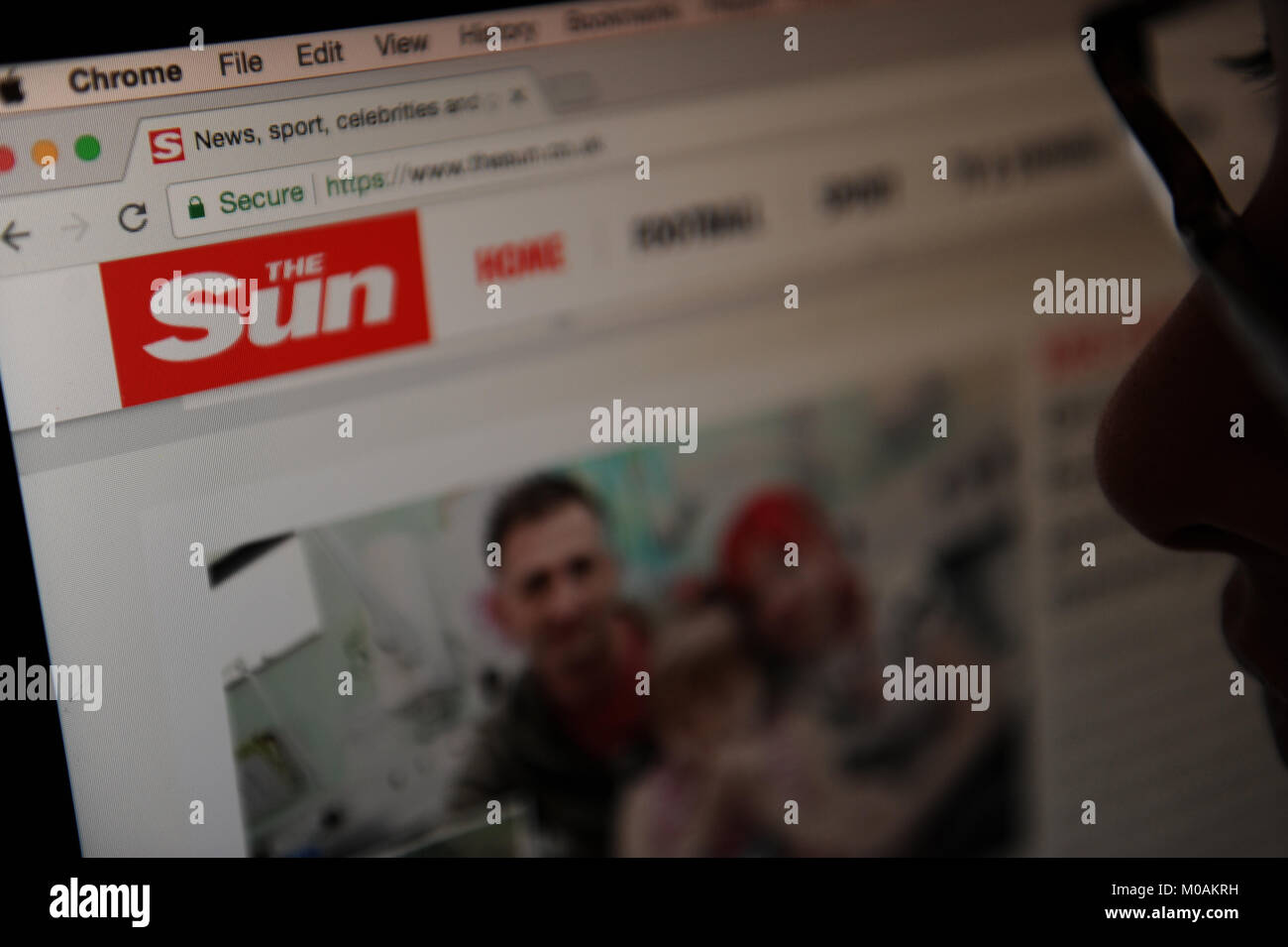 A woman looks at The Sun website Stock Photo - Alamy