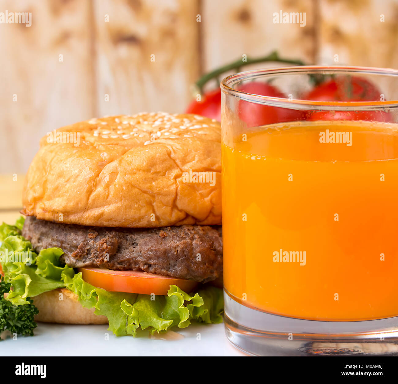 Burger And Juice Representing Orange Drink And Bbq Stock Photo - Alamy