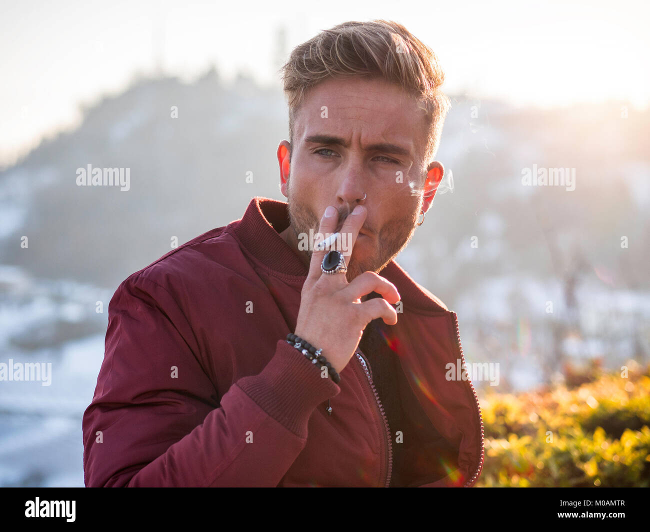 Young blond man smoking in hi-res stock photography and images - Alamy