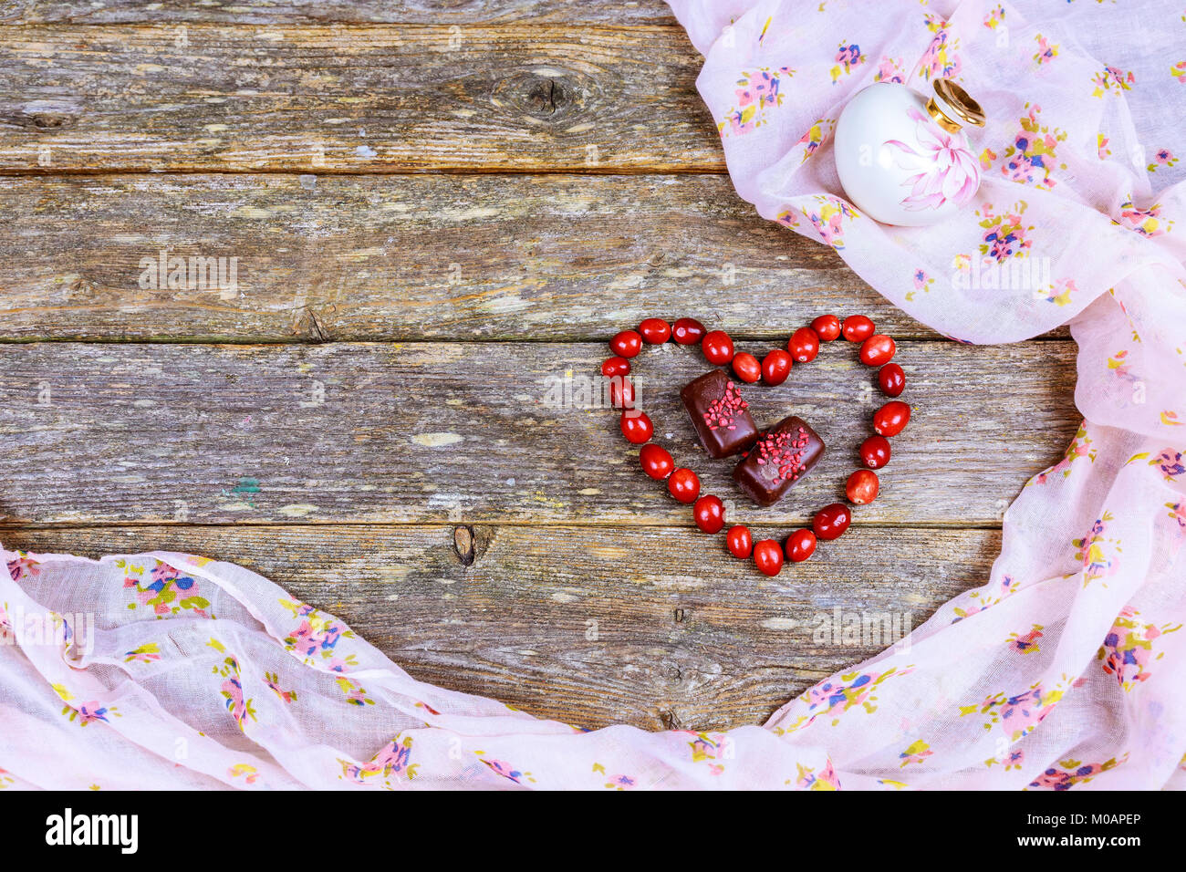 Heart laid out from buttons in the form of multi-colored paws on a ...
