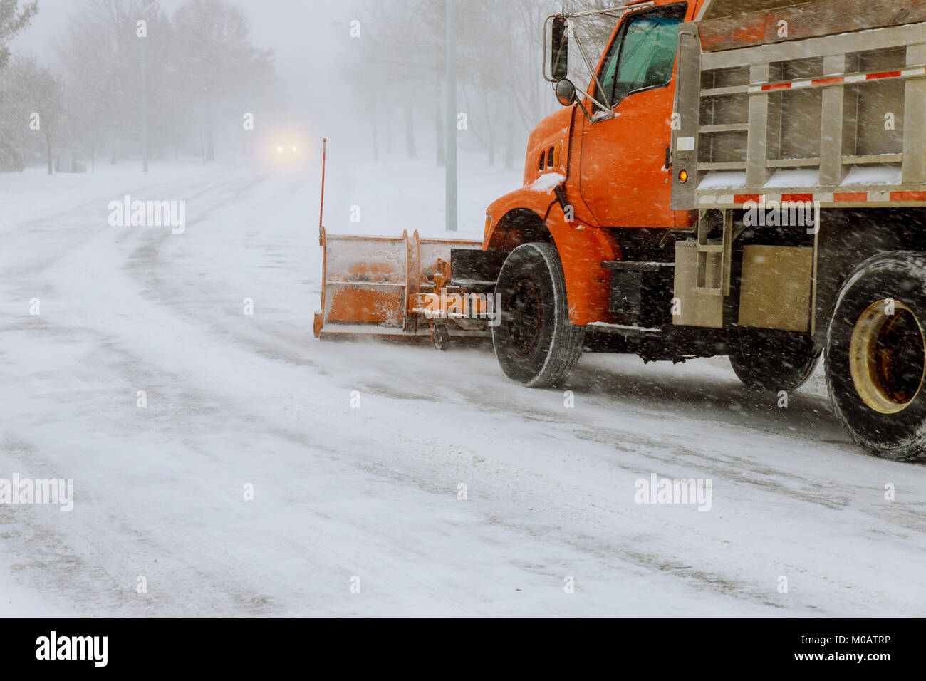 Tractor removing snow from a residential housing estate in winter Stock ...