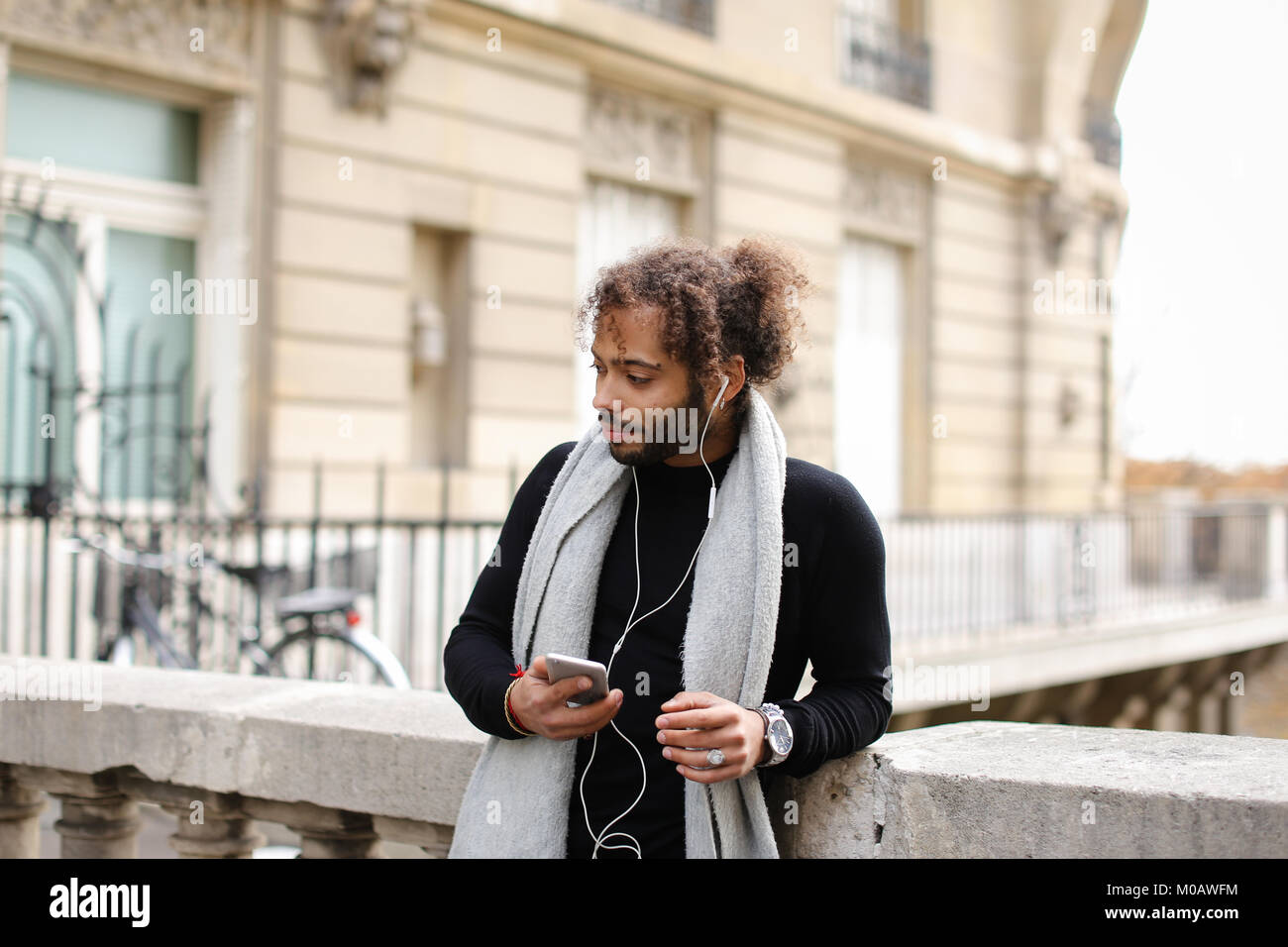 Mulatto male person chatting with friends by smartphone with ear Stock ...