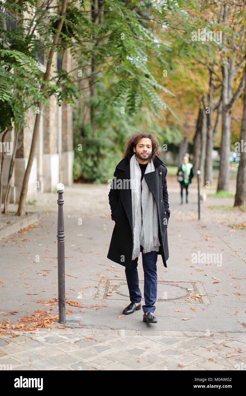 Young mix blood male person walking outside Stock Photo - Alamy