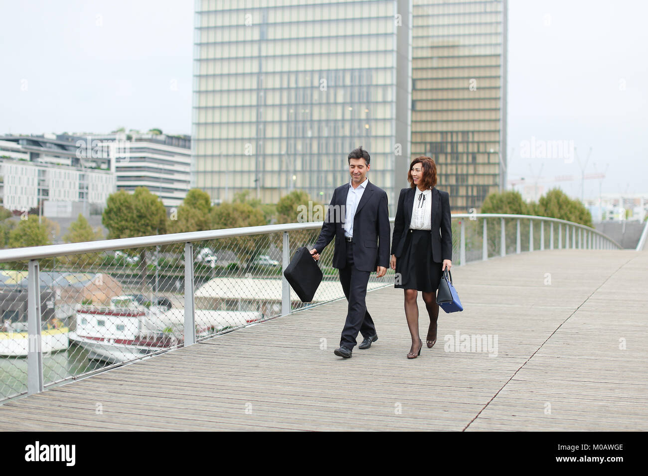 economists male and female in strict suits walking Stock Photo - Alamy