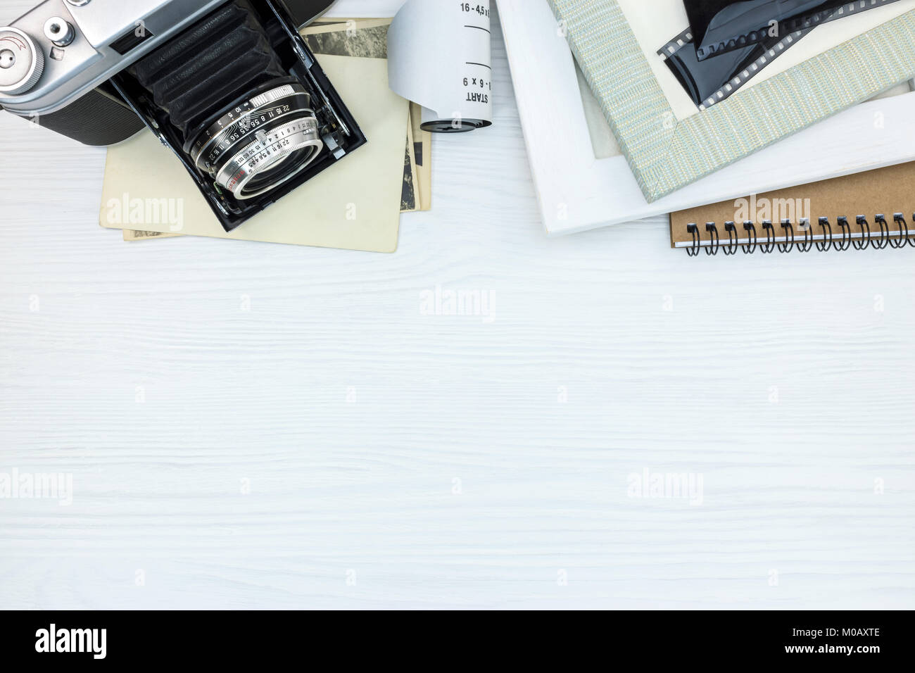 empty photo frames, old papers and vintage camera on white background ...