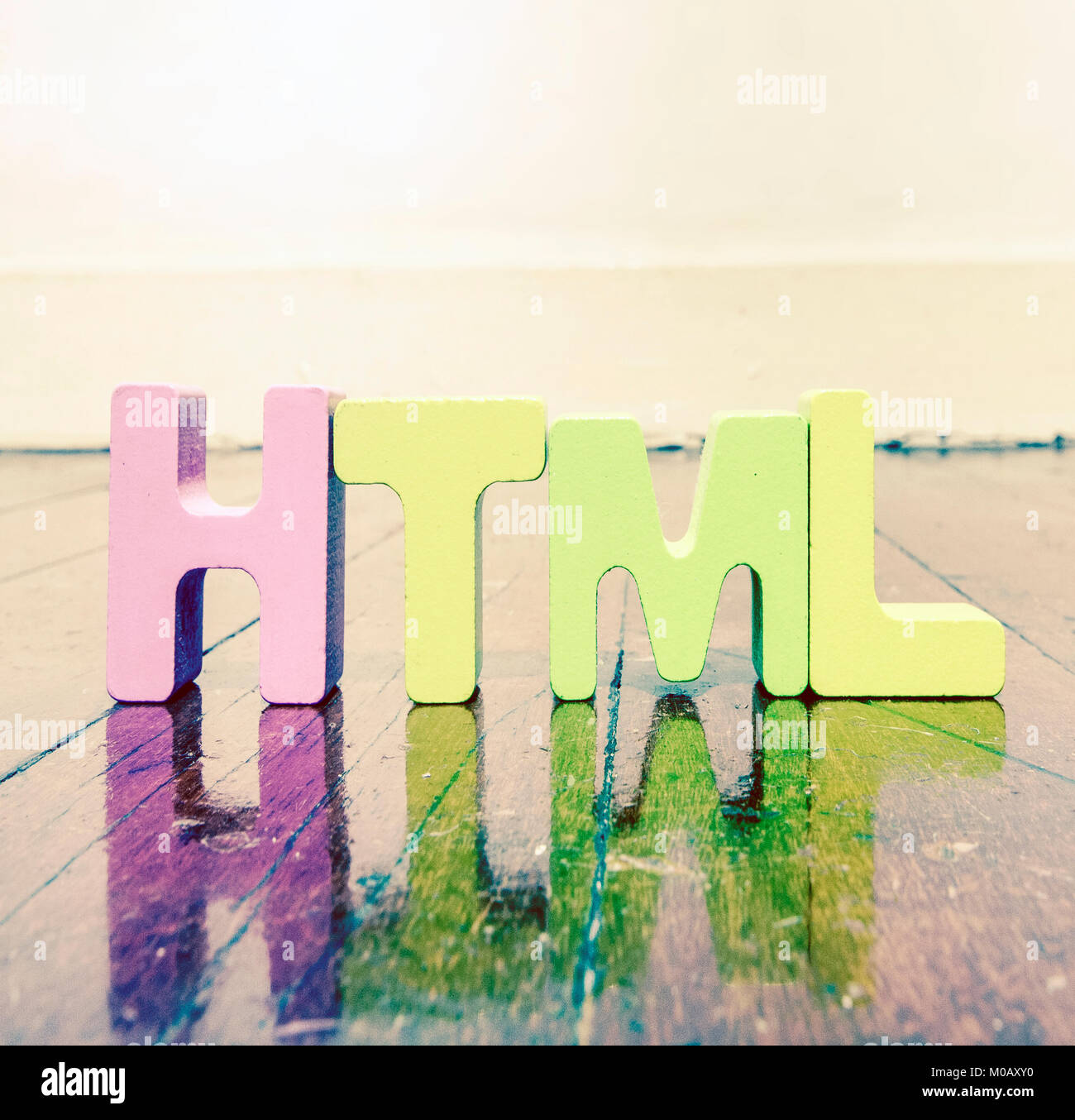 HTML text with wooden letters on an old wooden floor with reflection ...