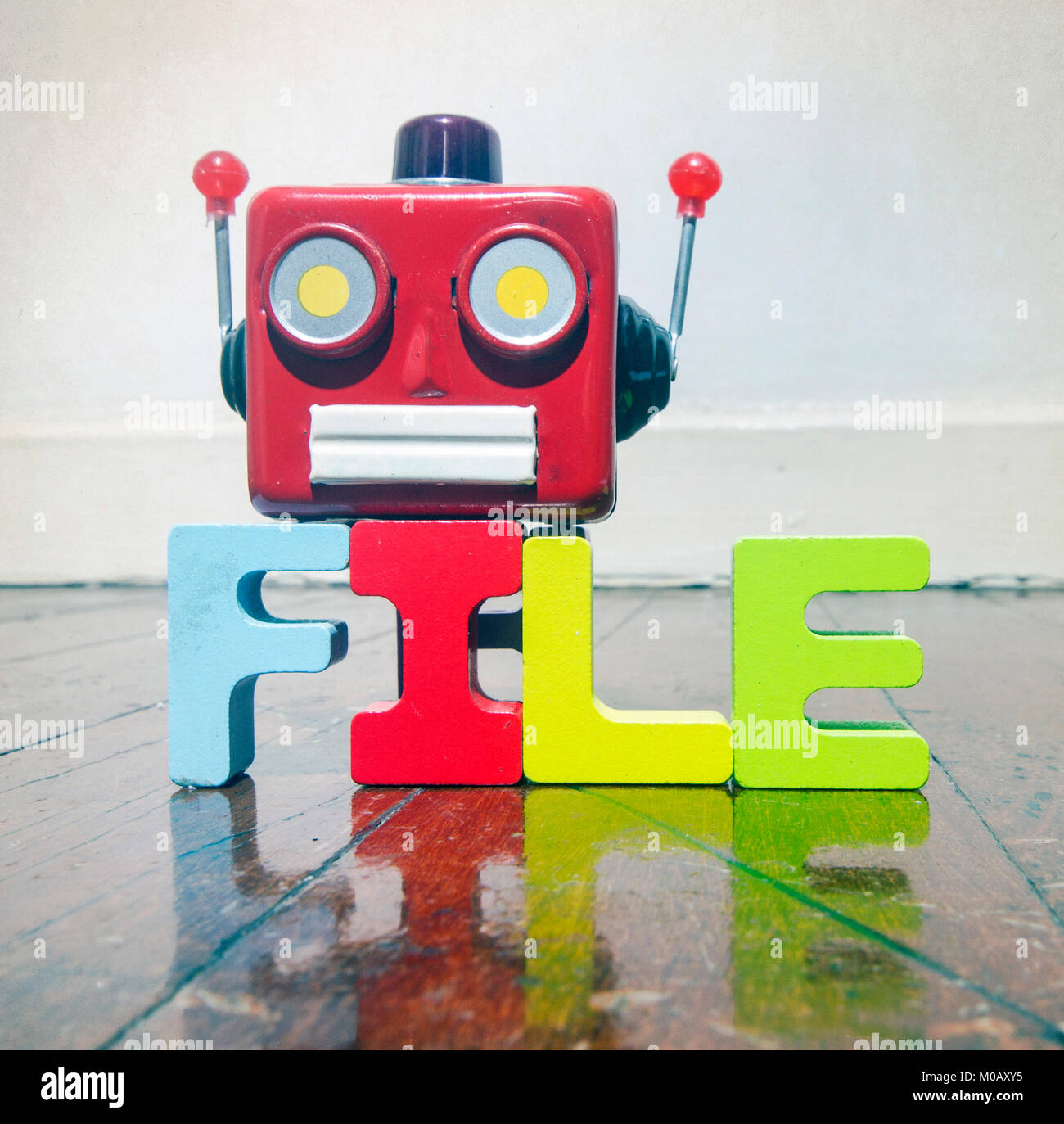 red retro robot head on the word FILE on old wooden flor Stock Photo ...